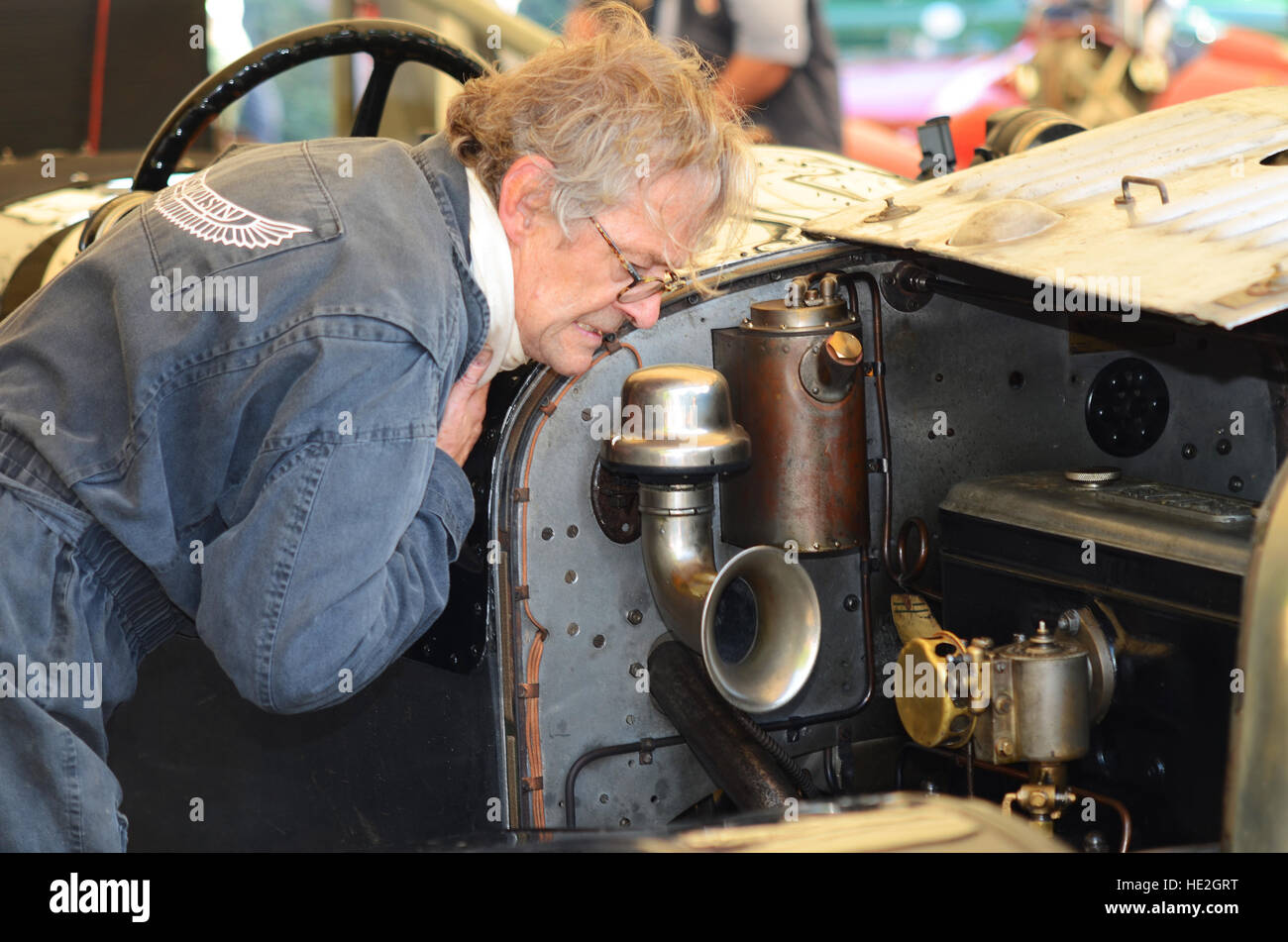 Reg Winstone inspecting the engine of a Voisin vintage car at the 2016 ...