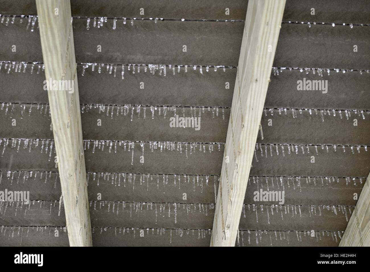 Ice cycles hanging from the deck of a home after a cold winter storm ...