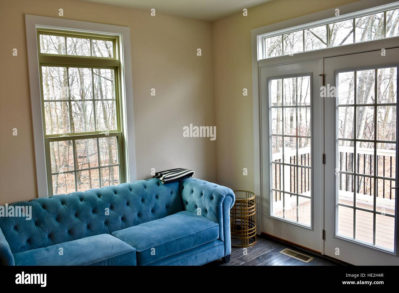 A home with beautiful windows looking into the woods with a nice blue ...