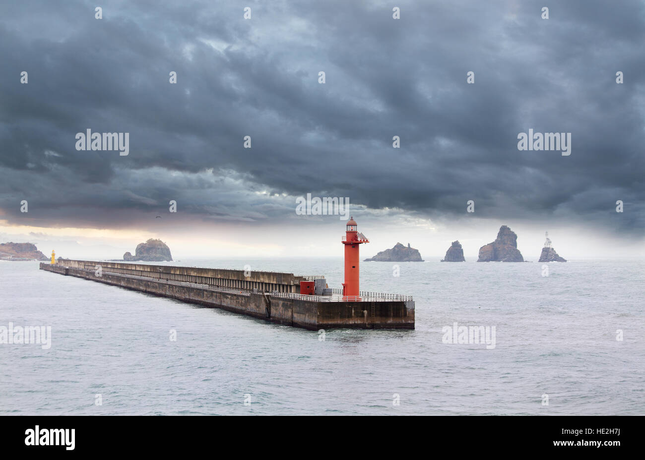 The image of a beacon on a concrete breakwater in storm weather Stock ...