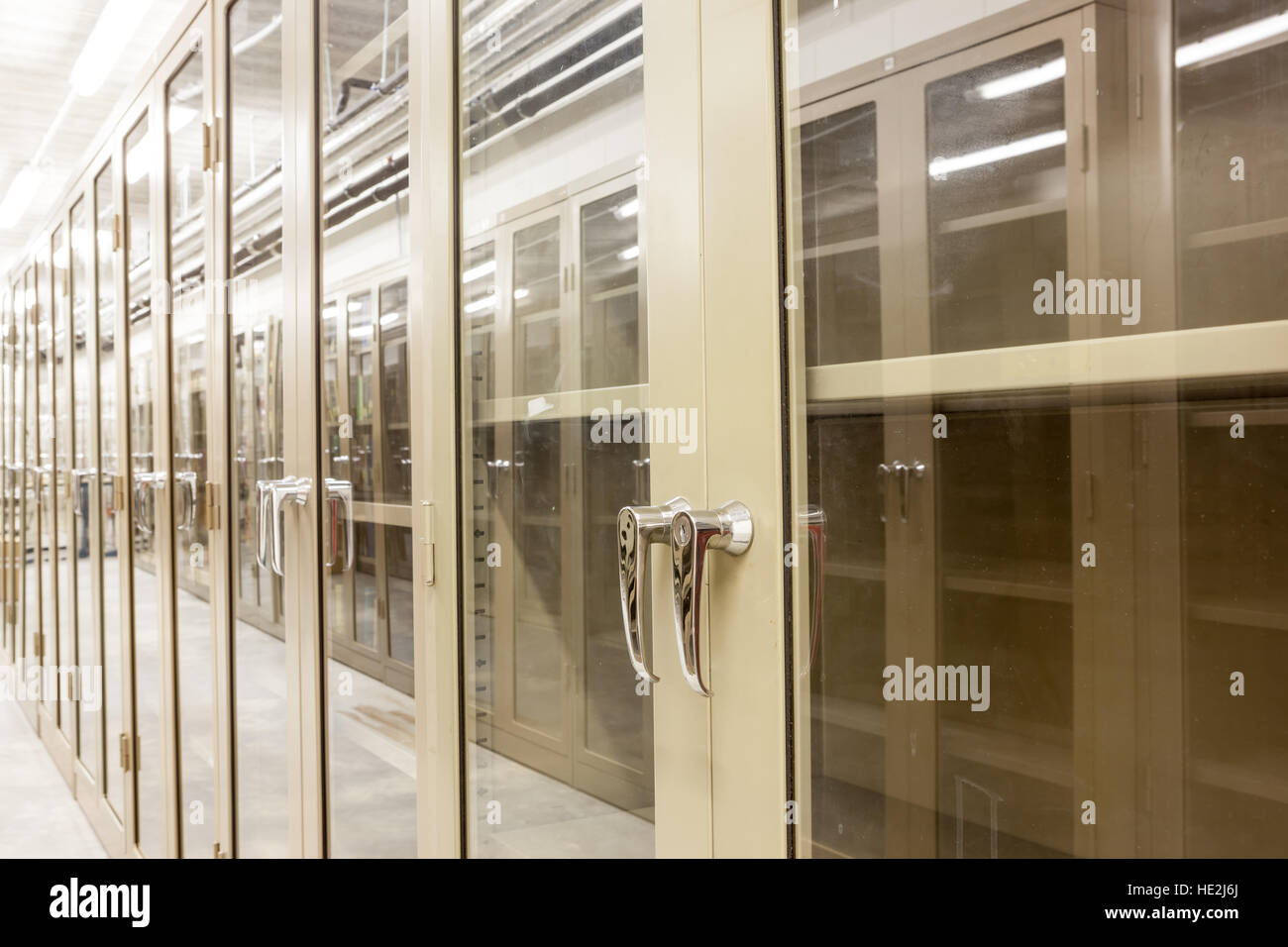an room with empty metal boxes with see-through glass Stock Photo - Alamy