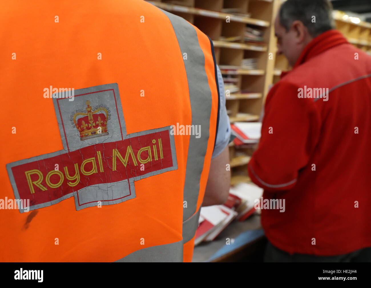 A Royal Mail worker sorts mail at the Royal Mail's Sorting Office in ...