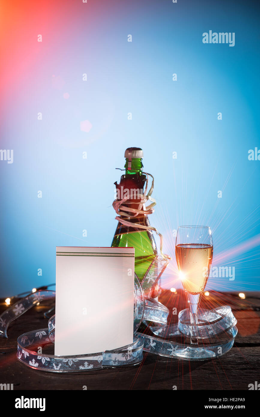 Glass and green bottle of champagne with blank card to write wishes ...
