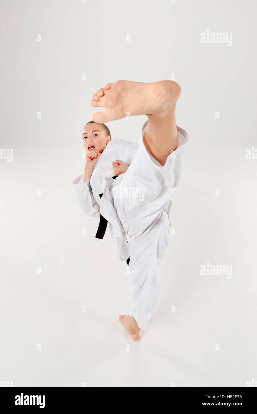 The karate girl in white kimono and black belt training karate over ...