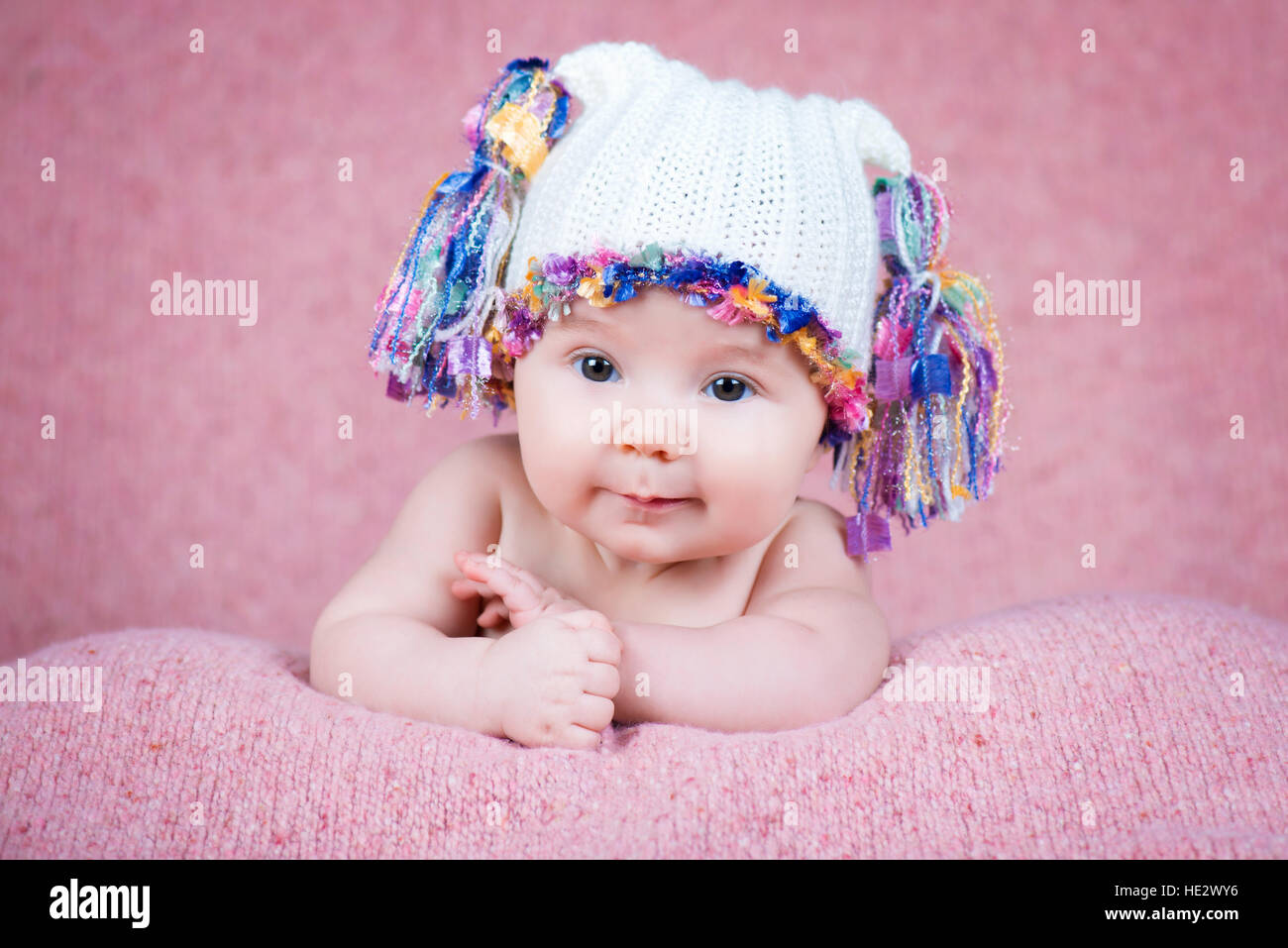 Beautiful little baby girl wearing pink knitted cap Stock Photo - Alamy