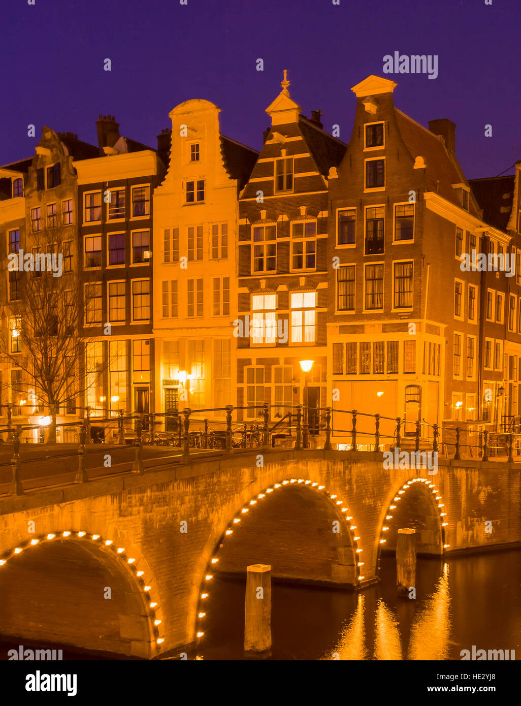 AMSTERDAM, NETHERLANDS - Canal bridge and architecture at night ...