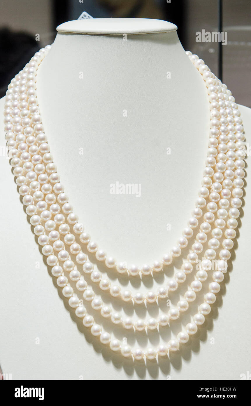 Strings of pearls on display stand at the Pearl factory Guilin, China ...