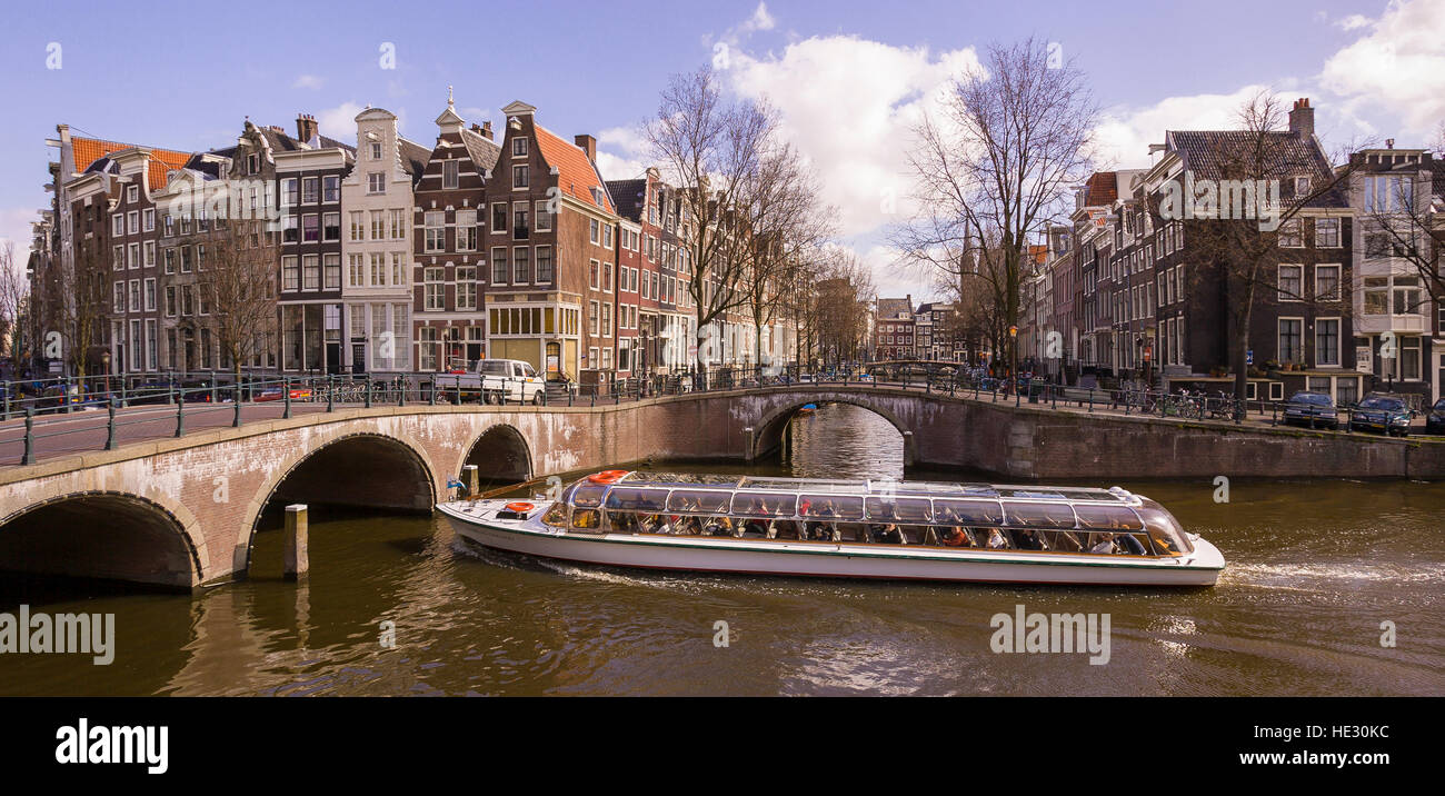 AMSTERDAM, NETHERLANDS - Canal boat and bridge Stock Photo - Alamy