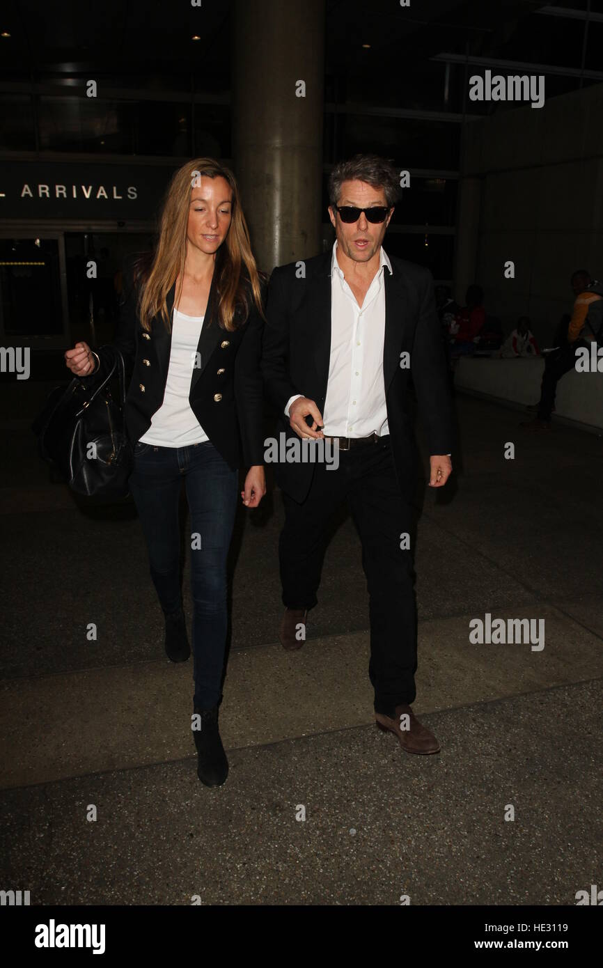 Hugh Grant arrives at the airport with his partner Featuring: Hugh ...