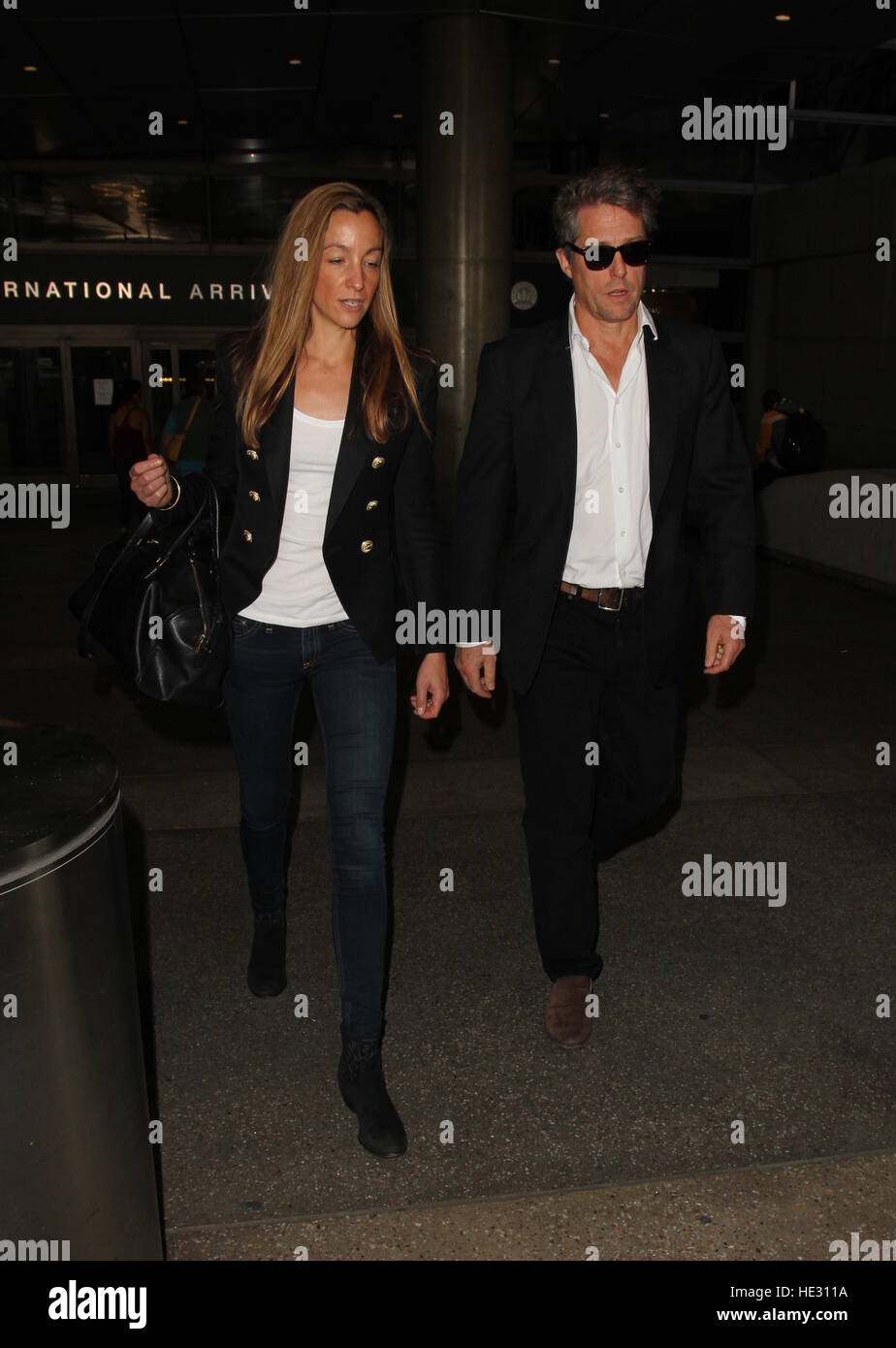 Hugh Grant arrives at the airport with his partner Featuring: Hugh ...