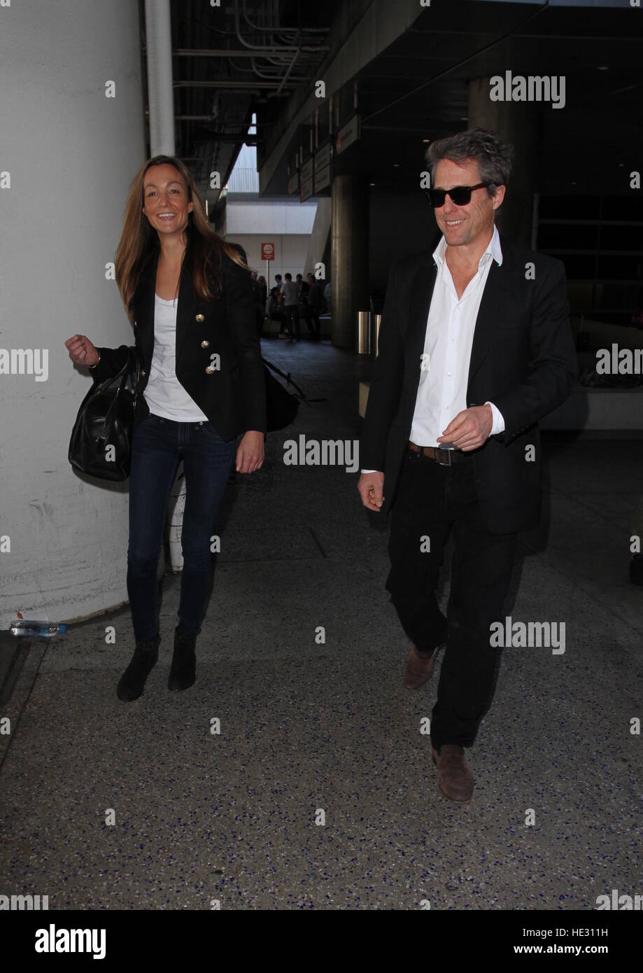 Hugh Grant arrives at the airport with his partner Featuring: Hugh ...