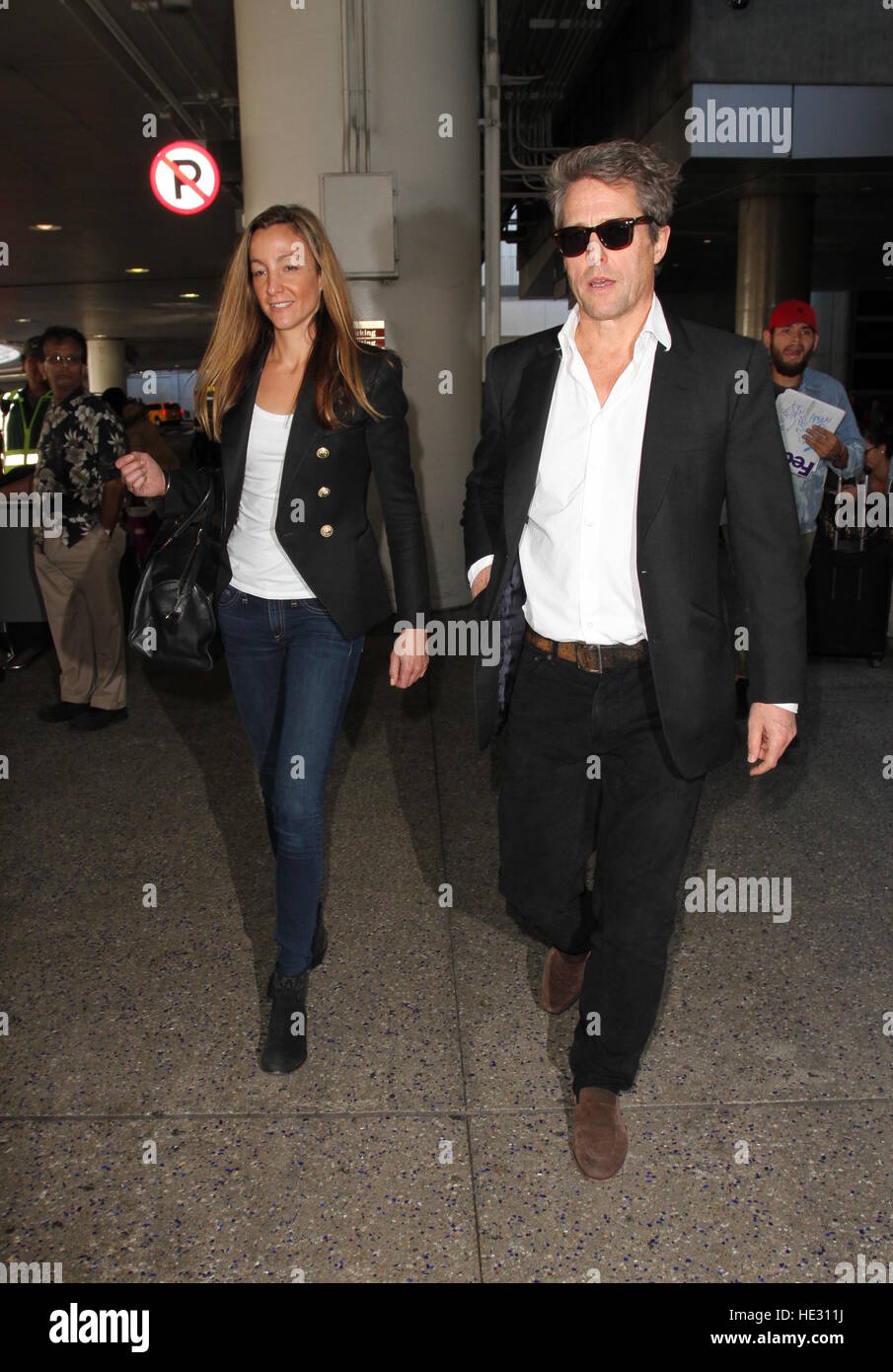 Hugh Grant arrives at the airport with his partner Featuring: Hugh ...