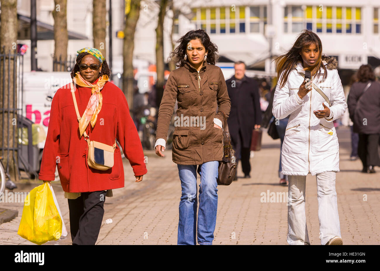 BIJLMER, AMSTERDAM, NETHERLANDS - Women walking on sidewalk in Bijlmer ...
