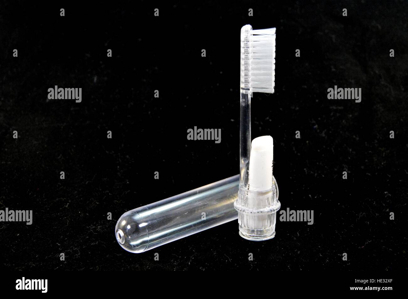 Transparent plastic toothbrush for travel on a black background Stock ...