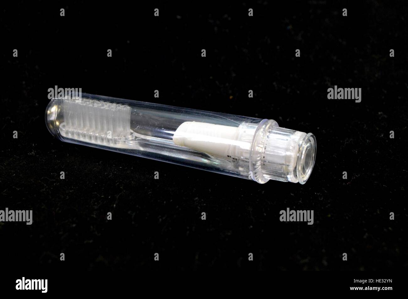 Transparent plastic toothbrush for travel on a black background Stock ...