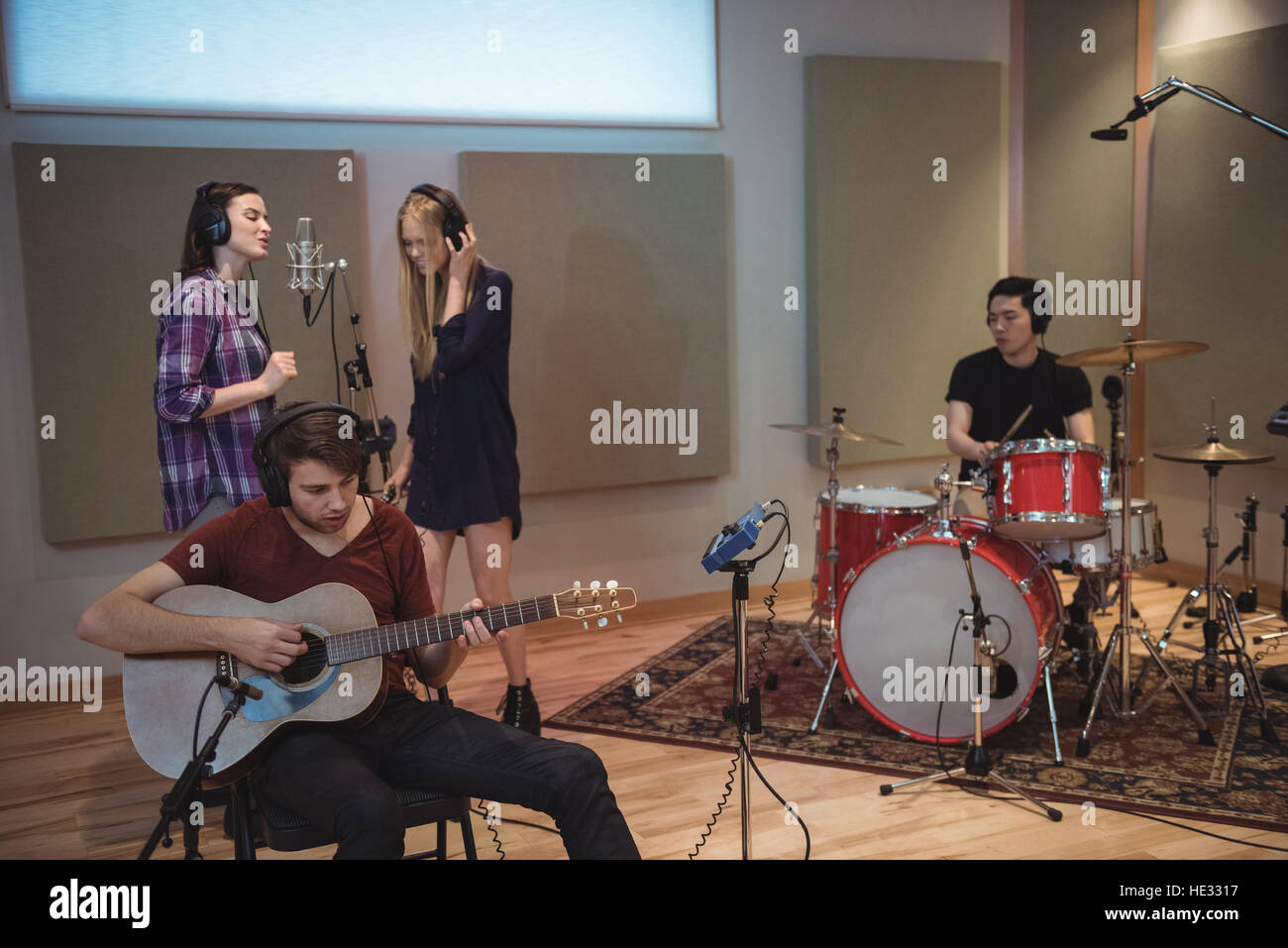 Music band performing in recording studio Stock Photo - Alamy