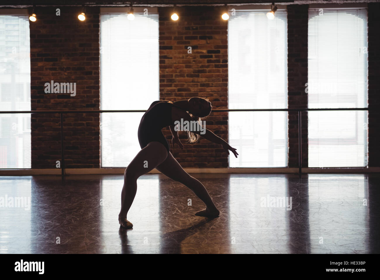 Ballerina performing ballet dance moves in ballet studio Stock Photo ...
