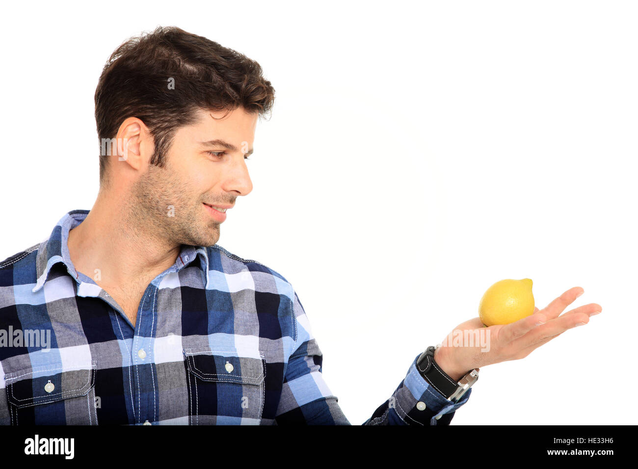 handsome man with a lemon in his hands isolated on a white background ...