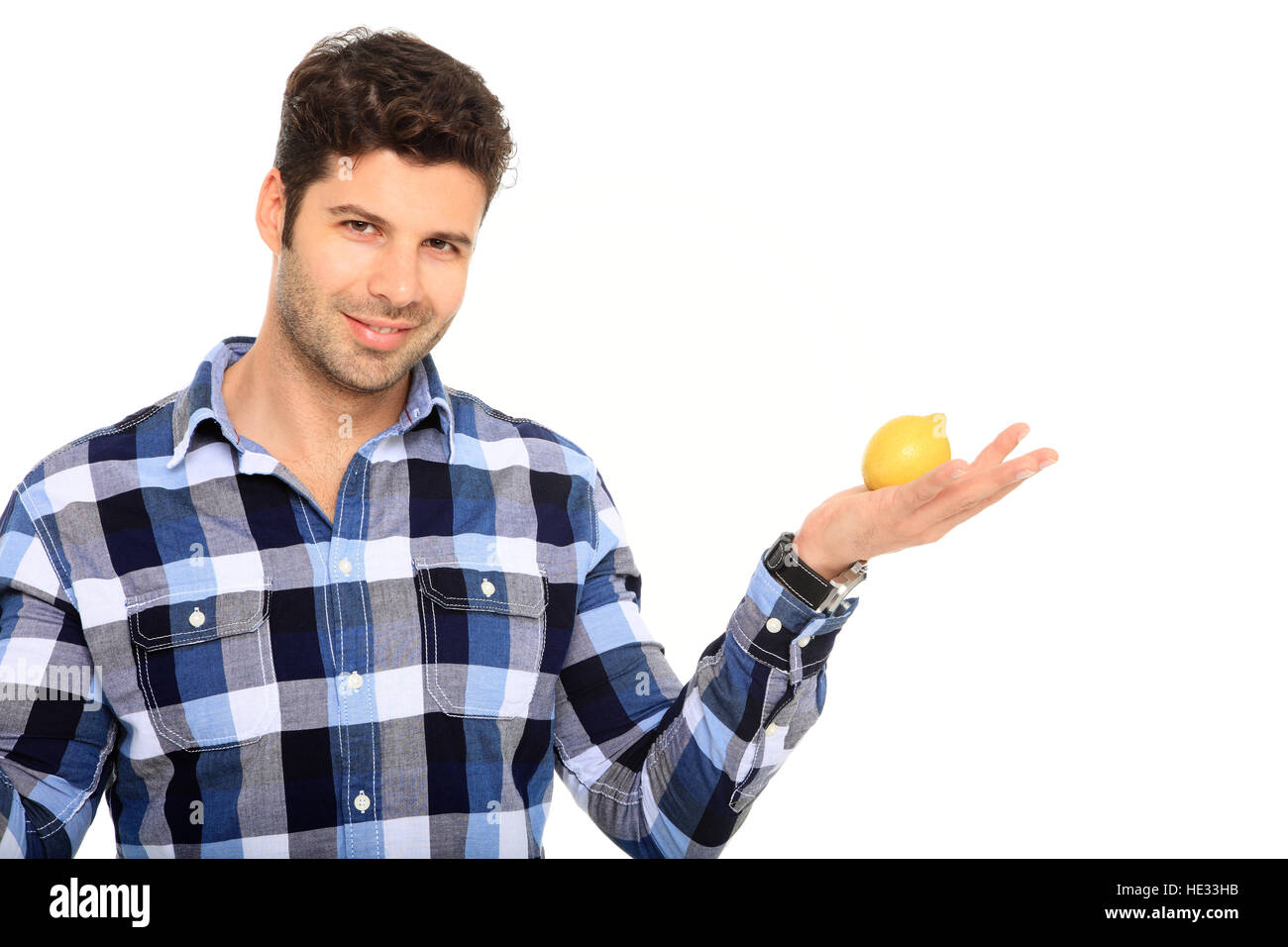 handsome man with a lemon in his hands isolated on a white background ...