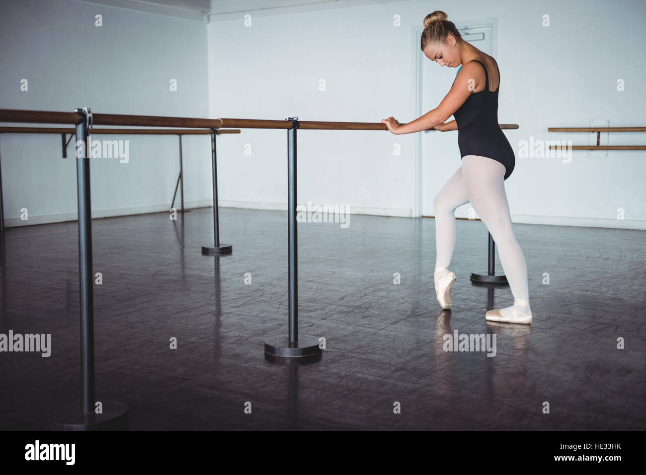 Ballerina practicing pointe at barre in ballet studio Stock Photo - Alamy