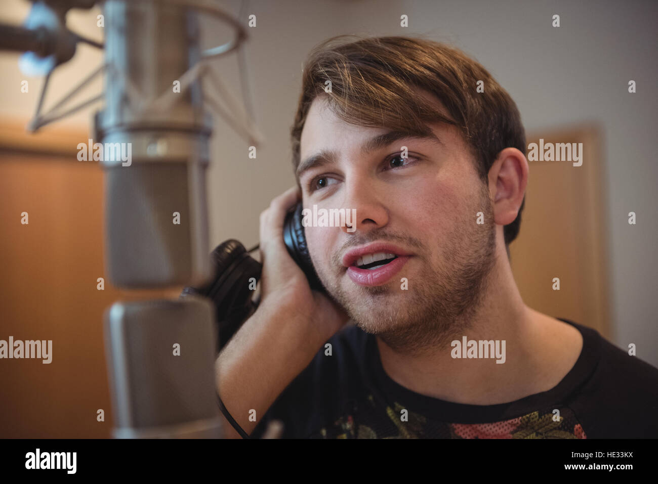 Singer performing in recording studio Stock Photo - Alamy