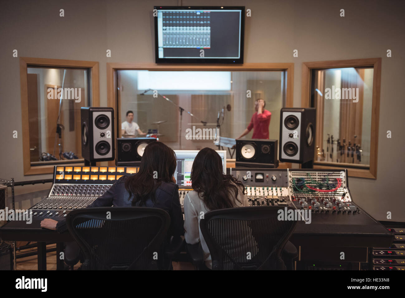 Audio engineers using sound mixer in recording studio Stock Photo - Alamy