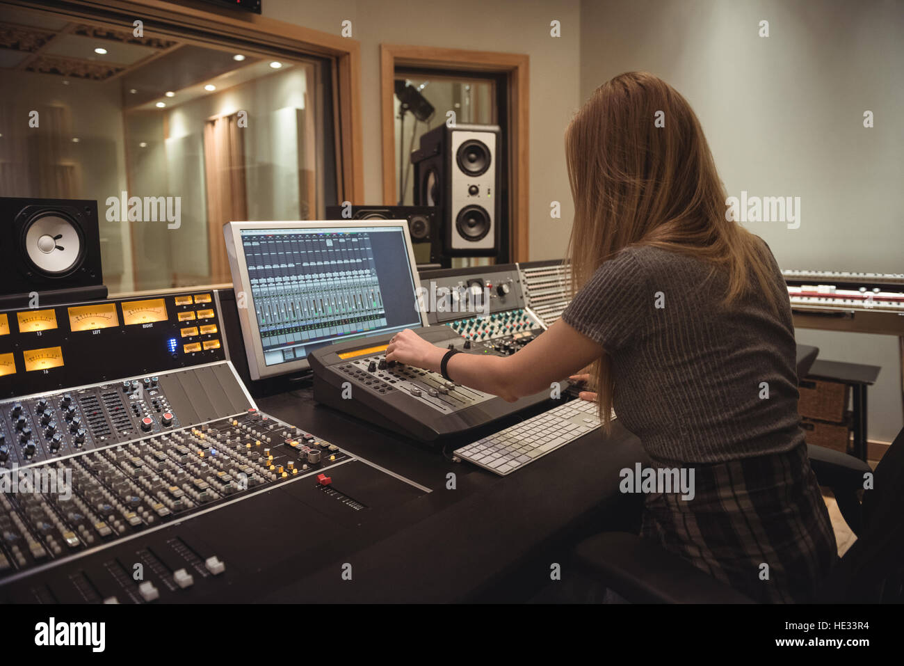 Audio engineer using sound mixer in recording studio Stock Photo - Alamy
