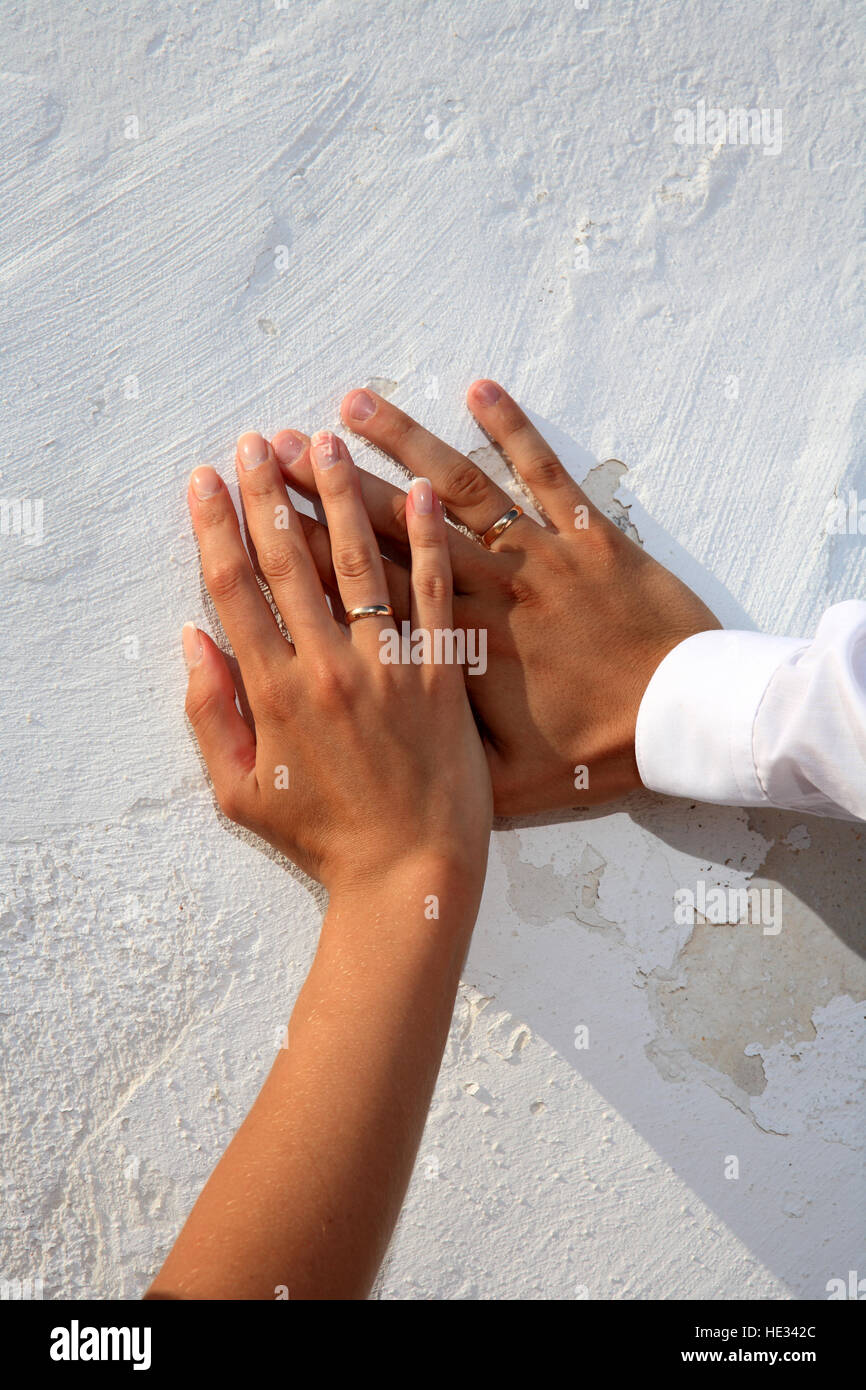 hands with wedding rings on the wall close up Stock Photo - Alamy