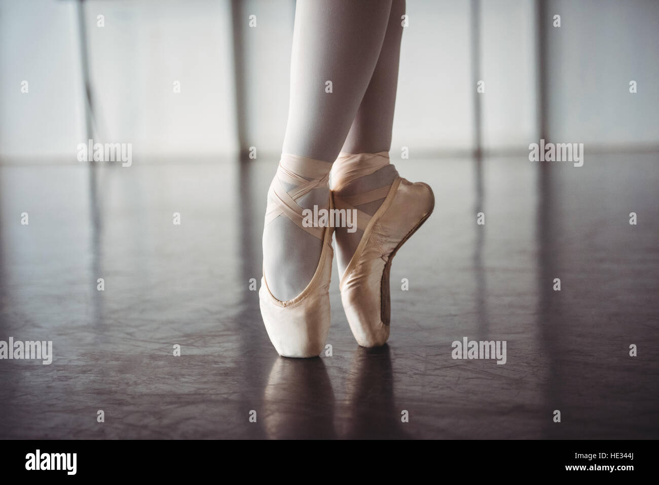 Feet of ballerina practising ballet dance in ballet studio Stock Photo ...