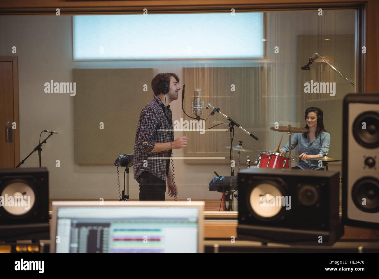Man singing on microphone in recording studio Stock Photo - Alamy