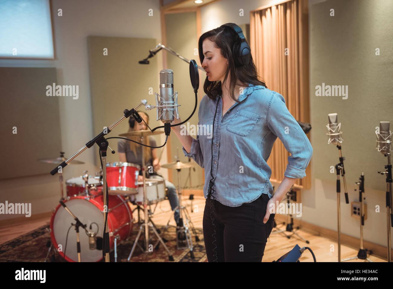Beautiful woman singing in recording studio Stock Photo - Alamy