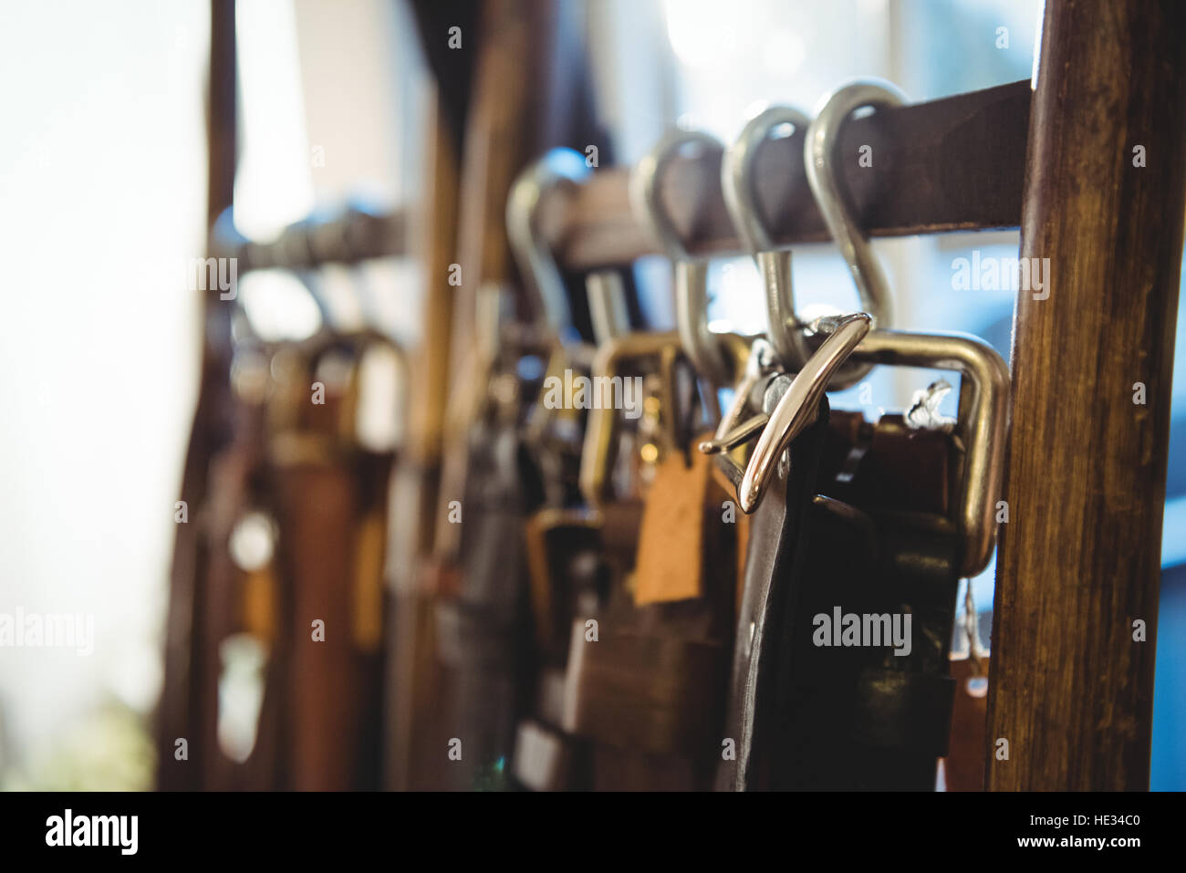 Various leather accessories hanging on hook in workshop Stock Photo - Alamy