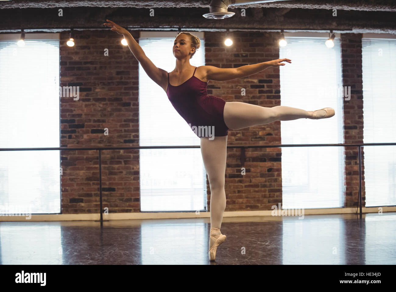 Ballerina practicing ballet dance at barre in ballet studio Stock Photo ...