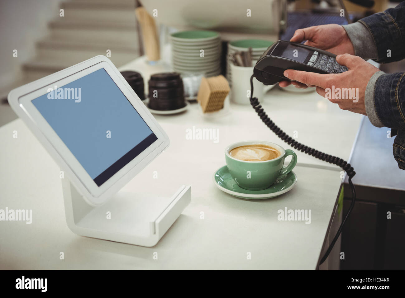 Hands of man using edc machine at billing counter in coffee shop Stock ...