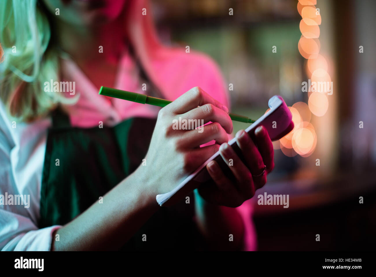 Waitress writing ordering on notepad hi-res stock photography and ...