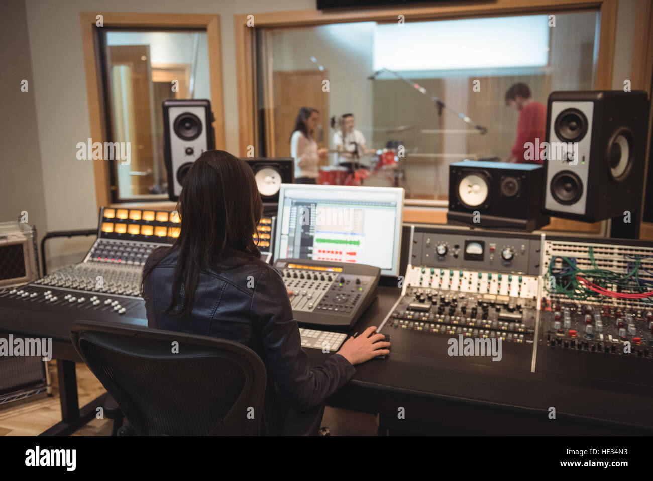 Audio engineer using sound mixer in recording studio Stock Photo - Alamy