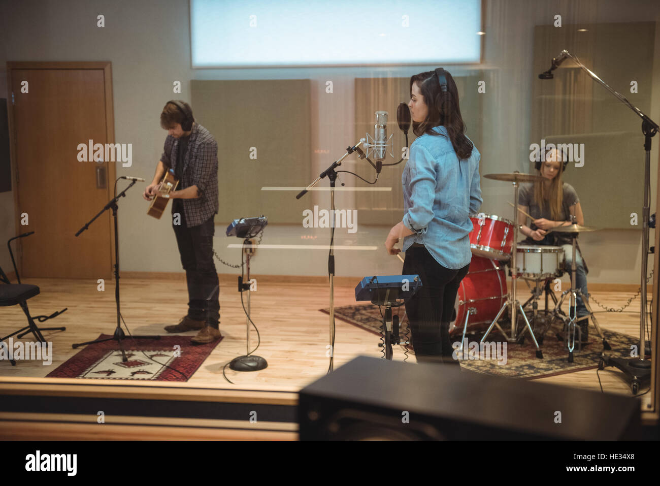 Music band performing in music studio Stock Photo - Alamy