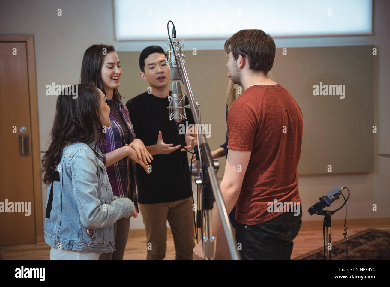 Singers performing in recording studio Stock Photo - Alamy