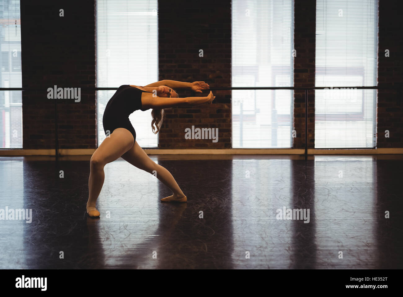 Ballerina performing ballet dance moves in ballet studio Stock Photo ...