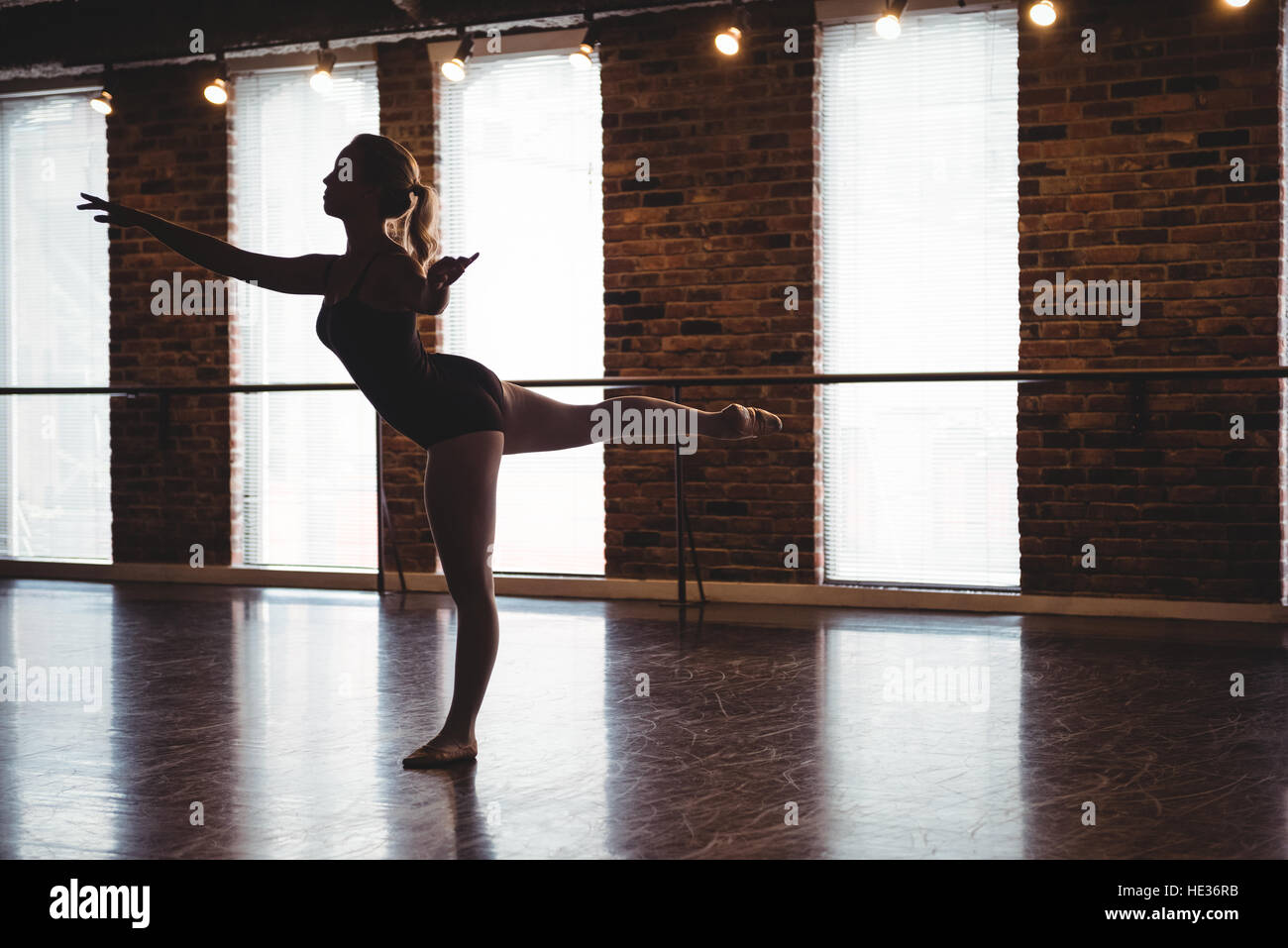 Ballerina performing ballet dance moves in ballet studio Stock Photo ...