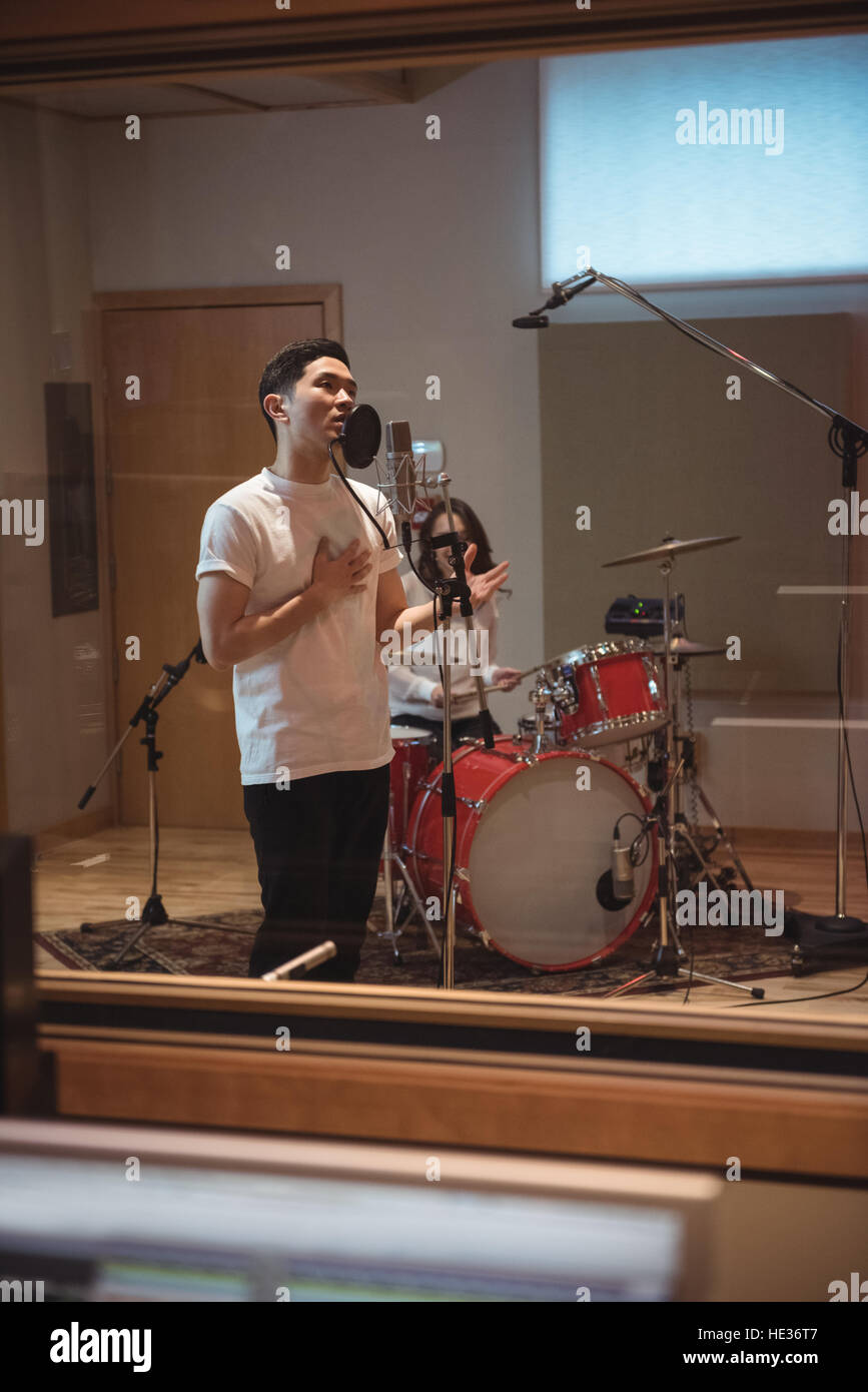 Man singing in recording studio Stock Photo - Alamy