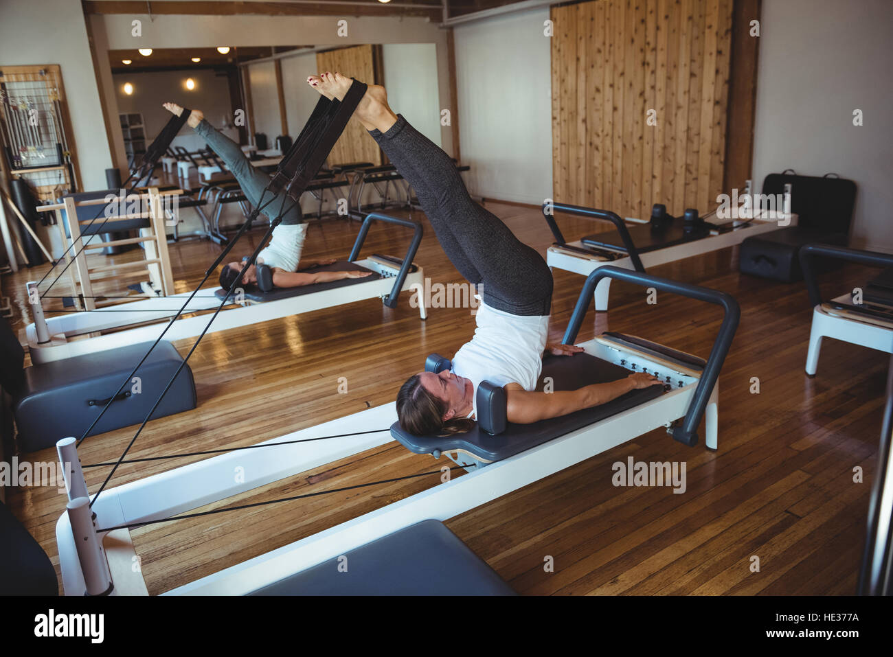Women practicing pilates on reformer in fitness studio Stock Photo - Alamy