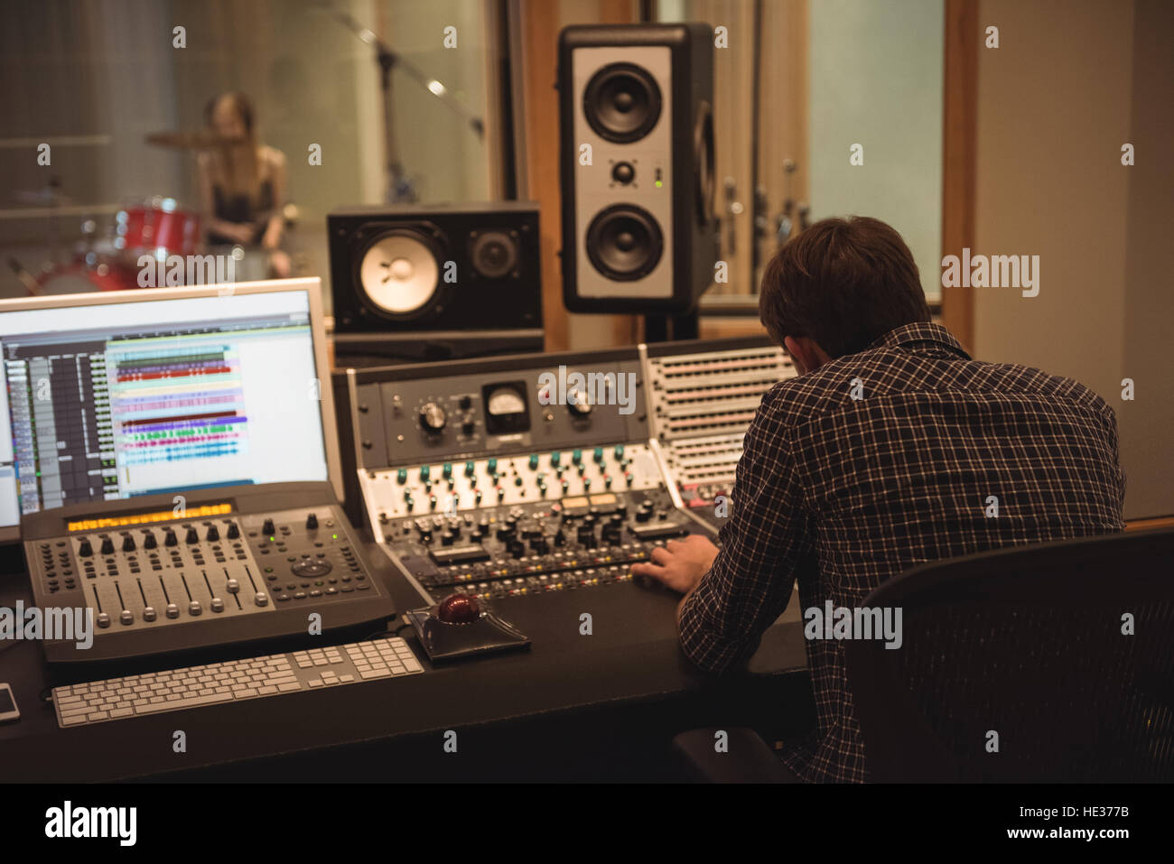 Rear view of audio engineer using sound mixer in recording studio Stock ...