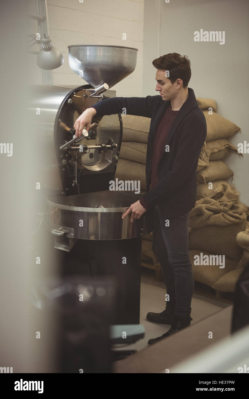 Man operating coffee roasting machine in coffee shop Stock Photo - Alamy