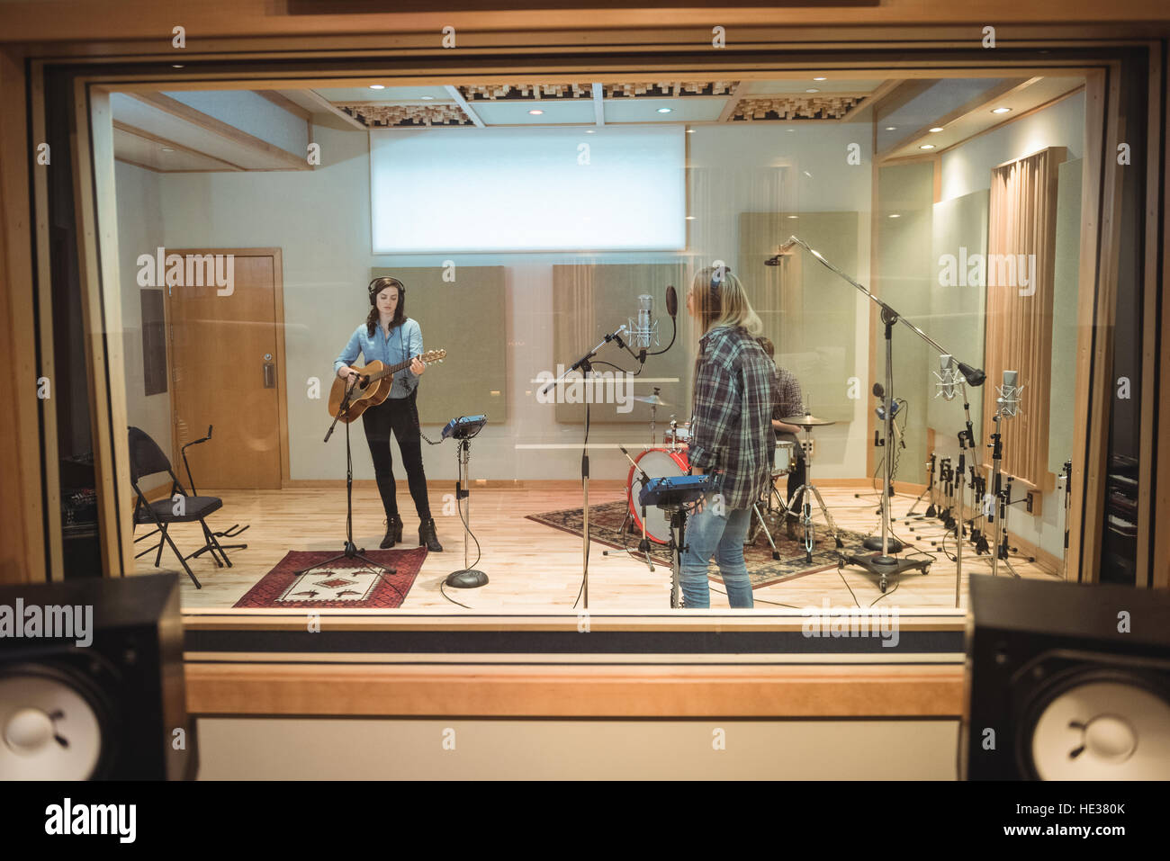 Music band performing in a recording studio Stock Photo - Alamy