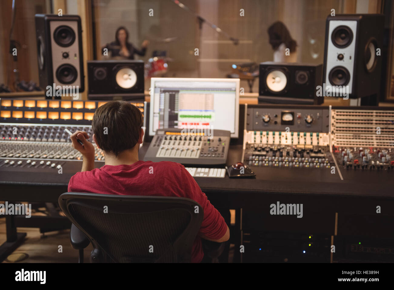 Audio engineer working on sound mixer in recording studio Stock Photo ...