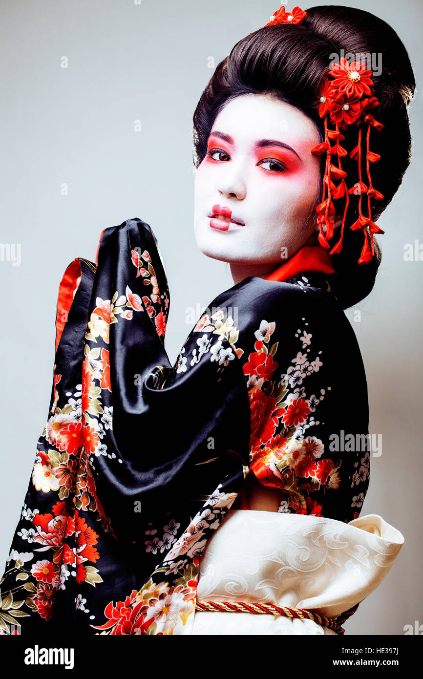 young pretty geisha in black kimono among sakura, asian ethno Stock ...