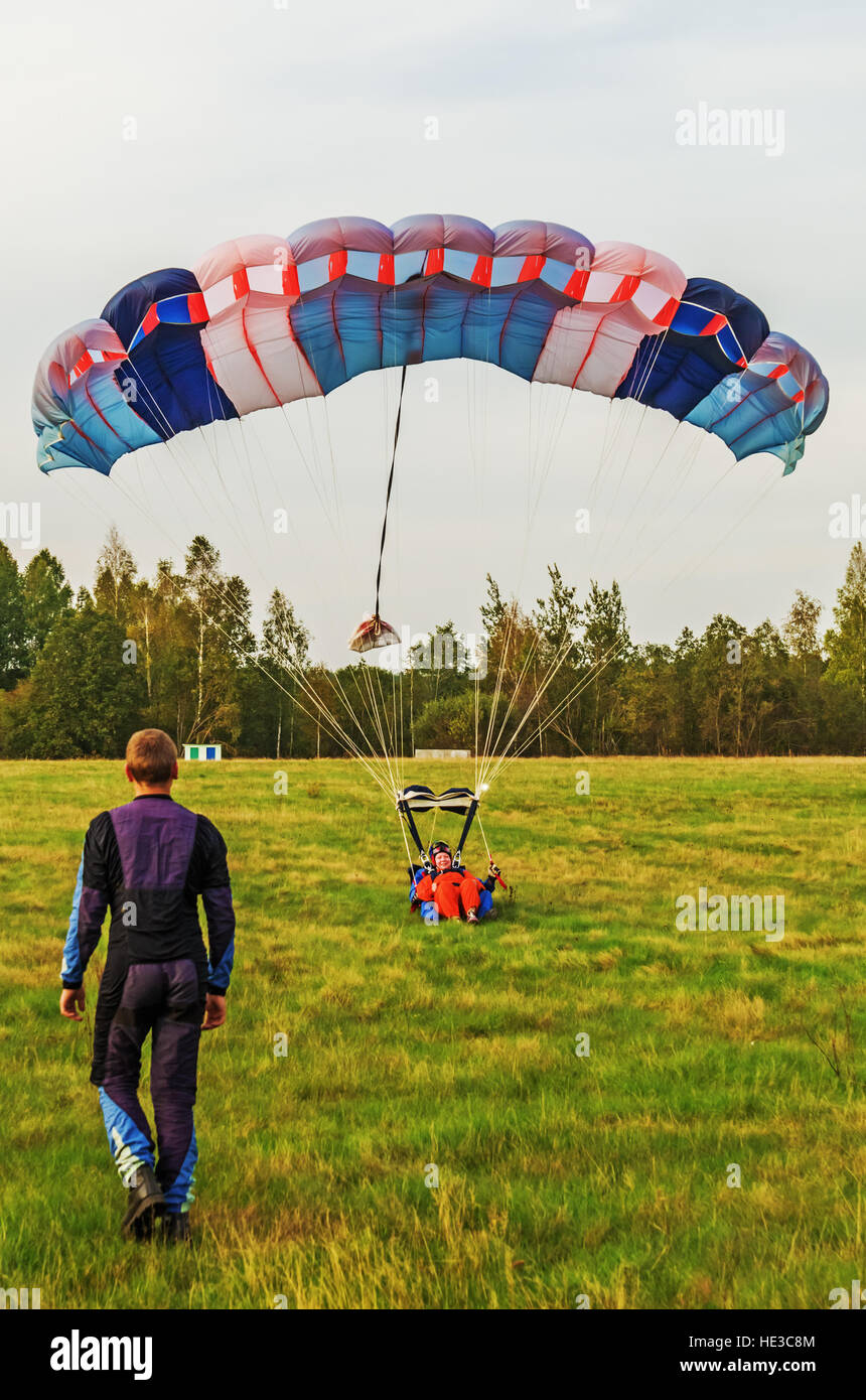 Parachutists - 2014.The skydivers landing under the parachute-tandem ...