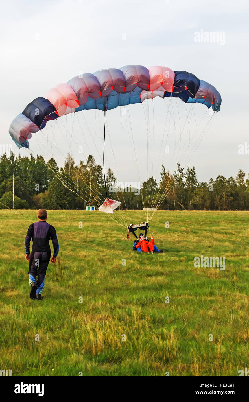 Parachutists - 2014.The skydivers landing under the parachute-tandem ...