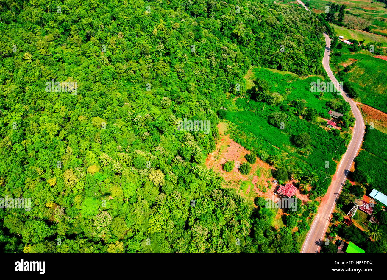Aerial view over mountain road going through forest landscape Stock ...